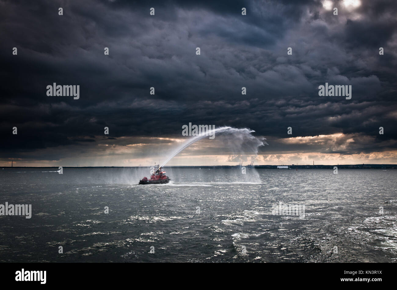 small fireboat demonstrating its capabilities on Baltic Sea in Gdansk ...