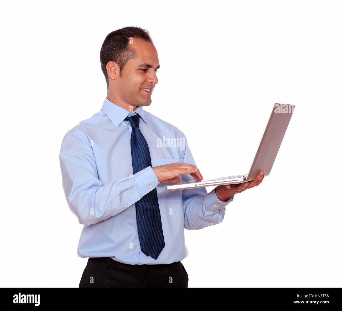 Portrait of an attractive man working with his laptop computer on ...