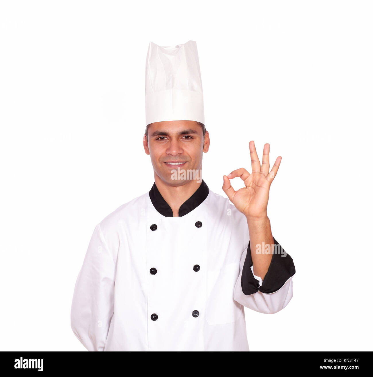 Portrait of a charming guy chef gesturing ok sign with fingers on white ...