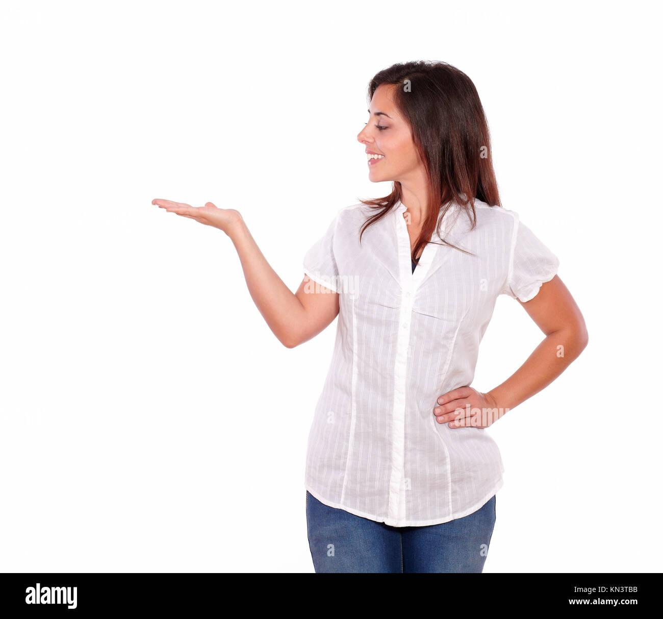 Portrait of a smiling hispanic lady holding palm out on isolated ...