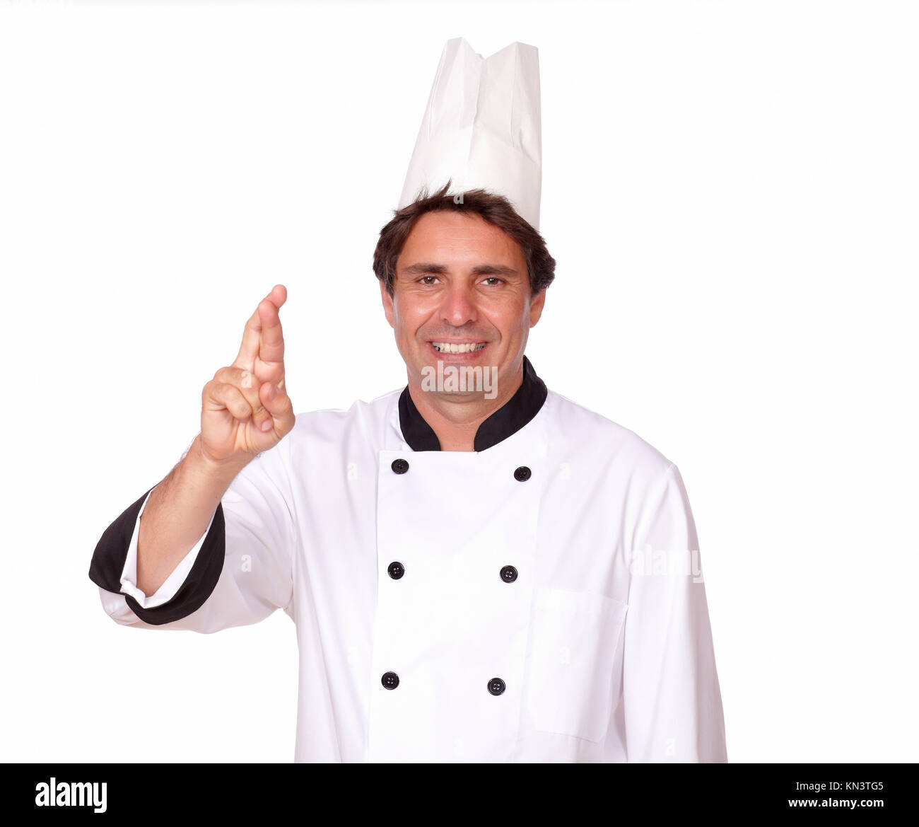 Portrait of smiling latin cook in uniform crossing fingers on isolated ...