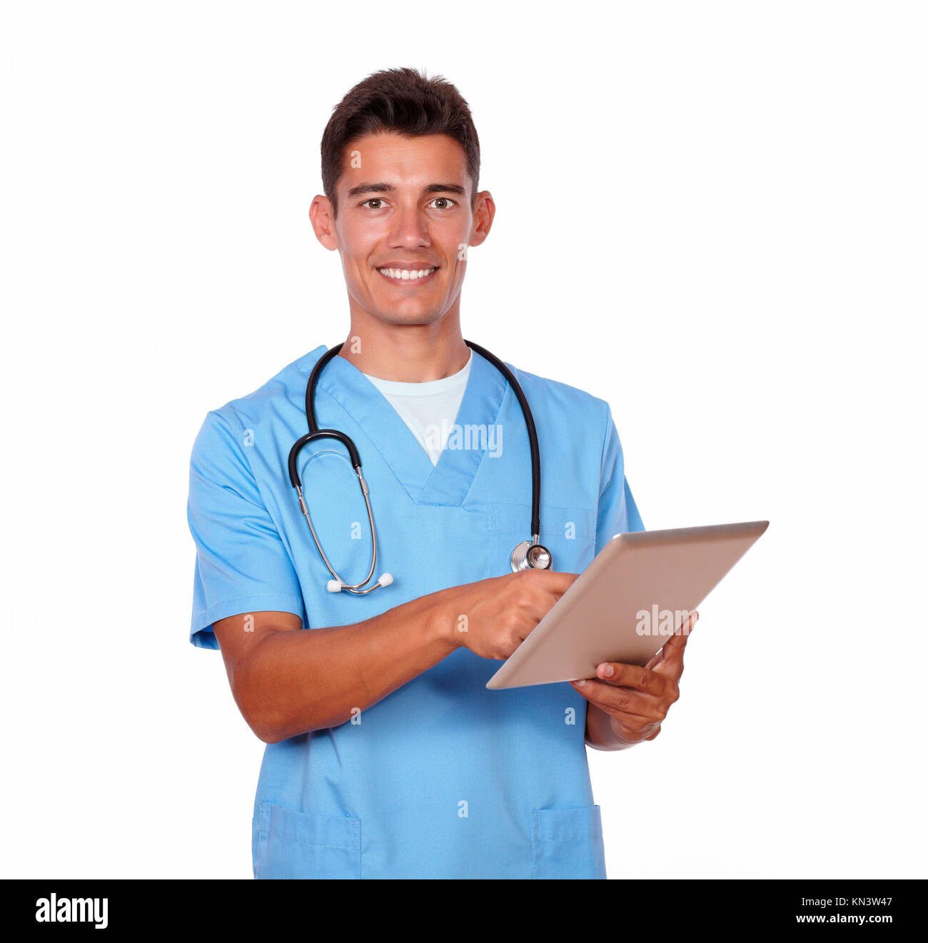 Portrait of a charming male nurse working on tablet pc while standing ...
