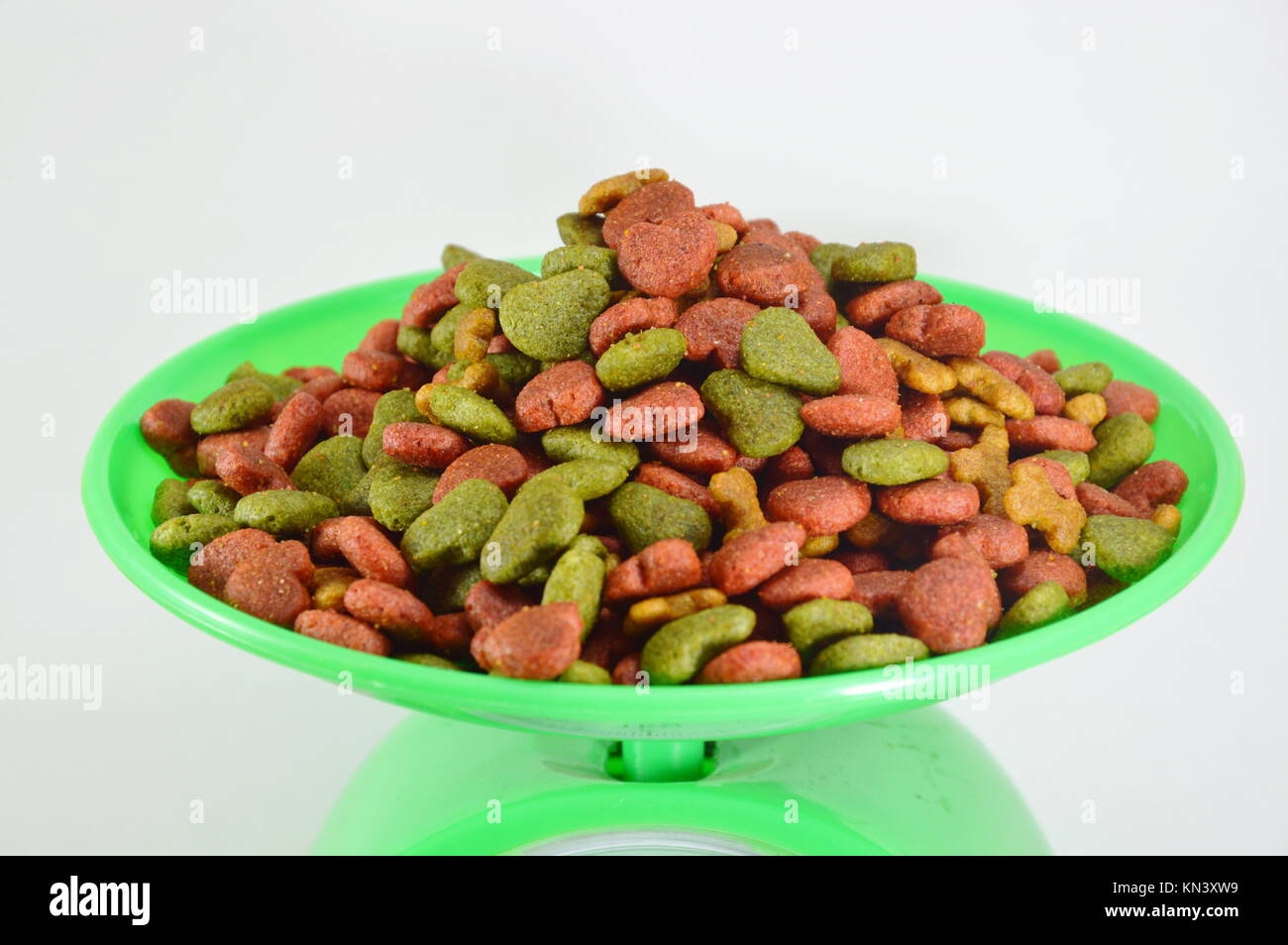dog food on green weighing scale Stock Photo - Alamy