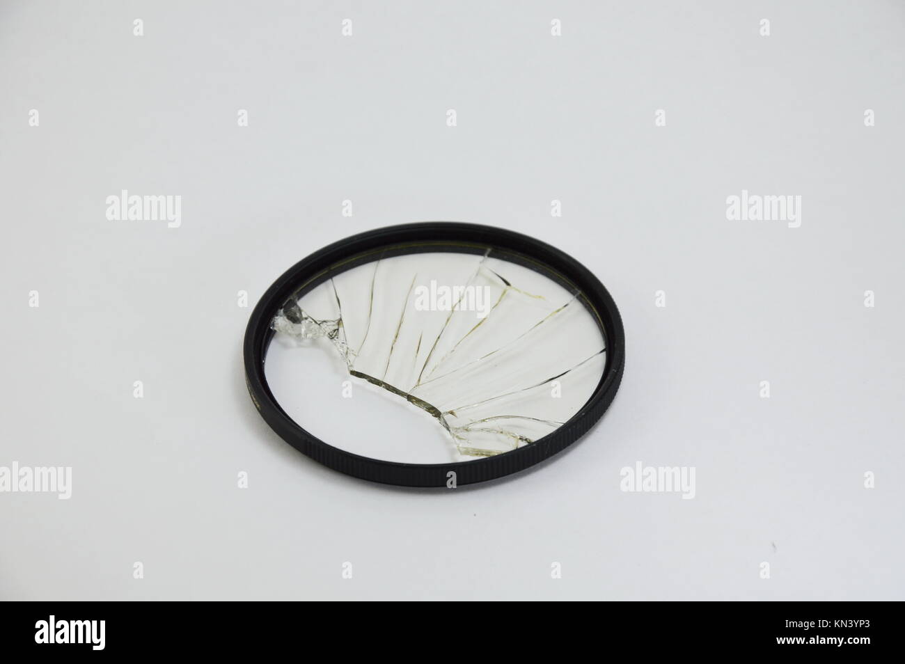 broken camera filter on white background Stock Photo - Alamy