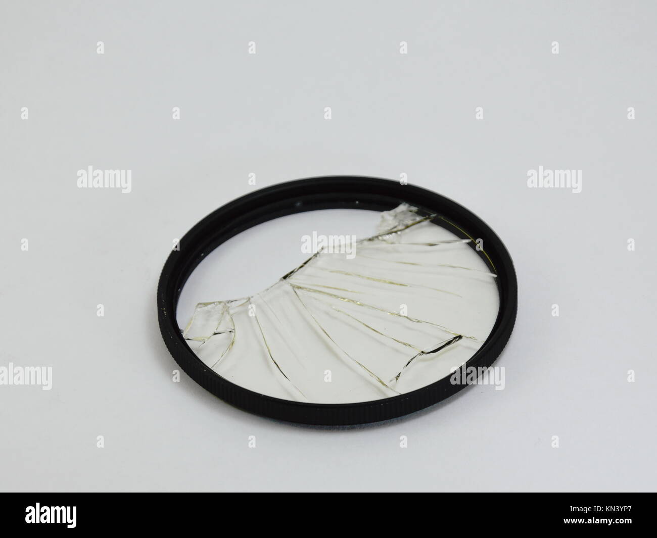 broken camera filter on white background Stock Photo - Alamy