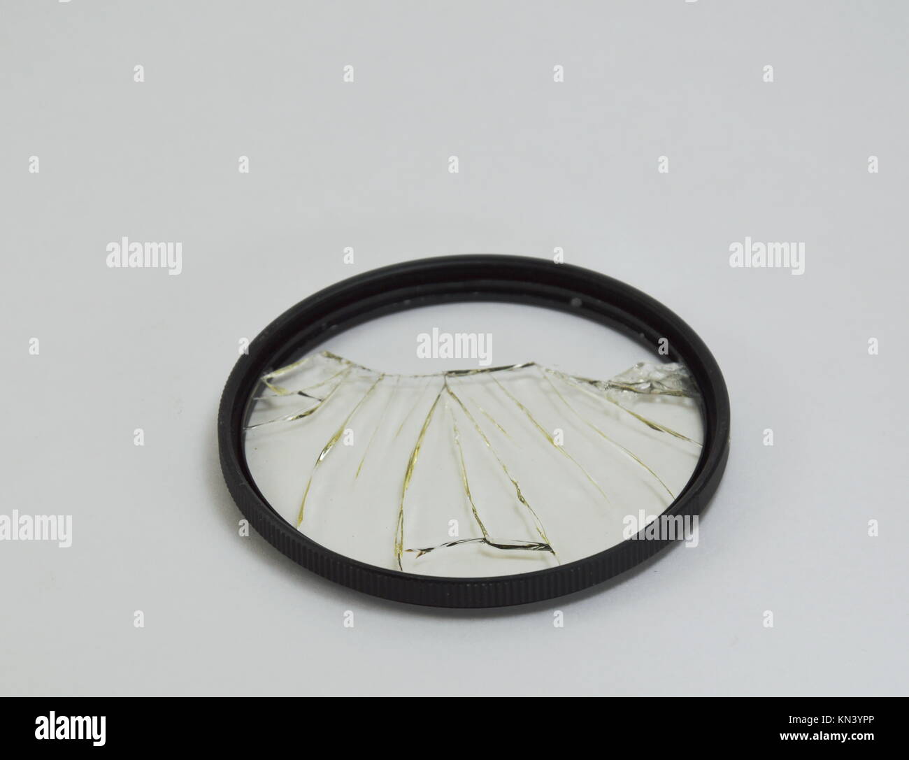 broken camera filter on white background Stock Photo - Alamy