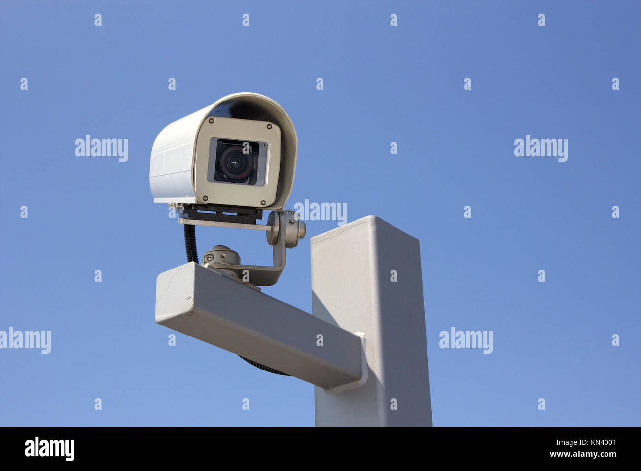 Security camera facing right before the background of a clear blue sky ...