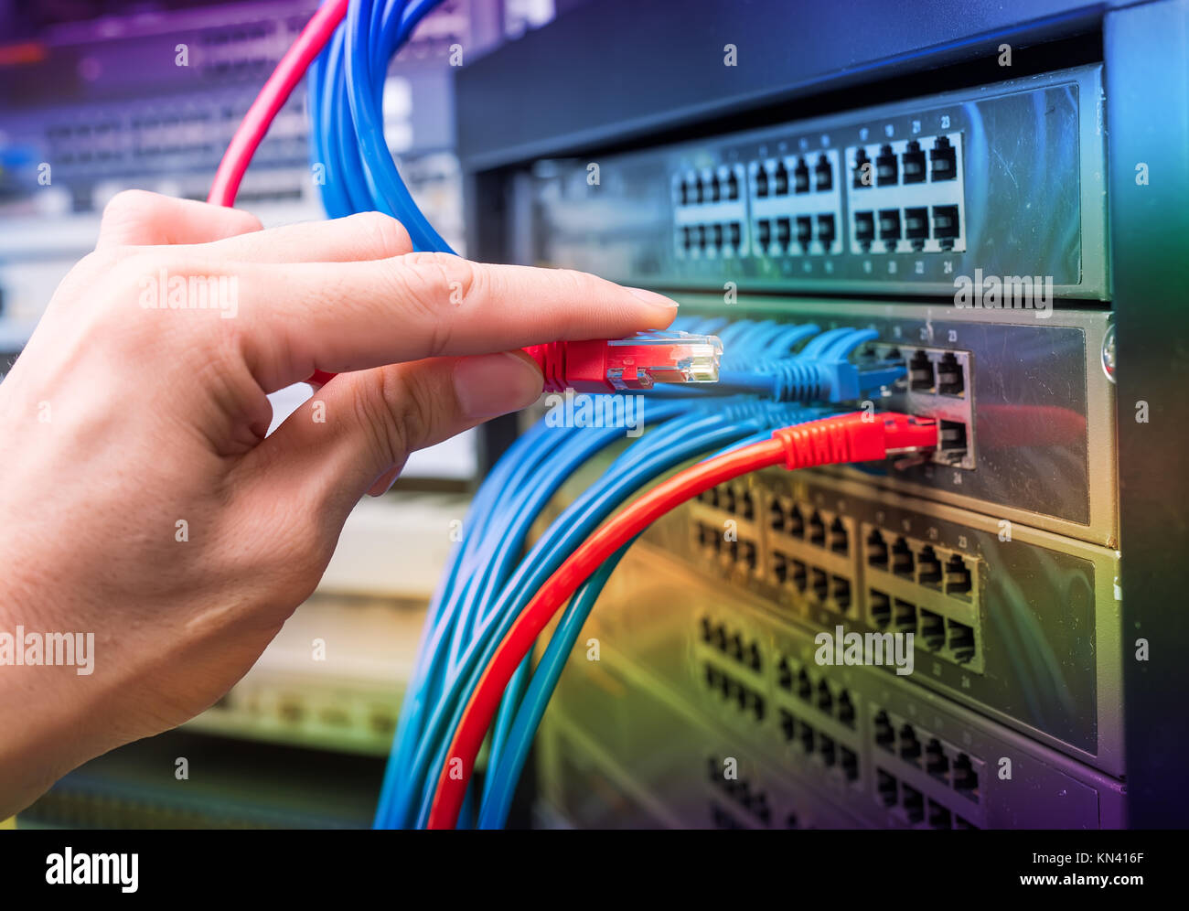 hand with network cables connected to servers in a datacenter Stock ...