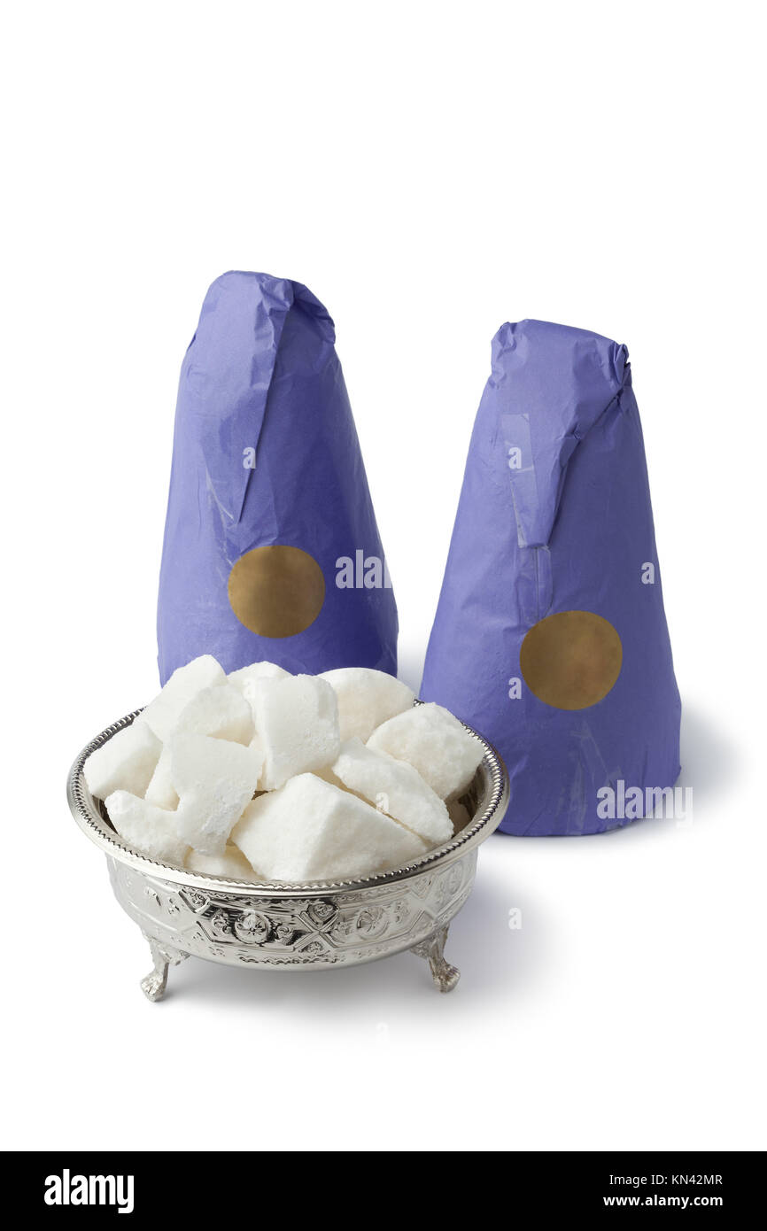 Traditional Moroccan bowl with sugar and sugar cones on the background ...