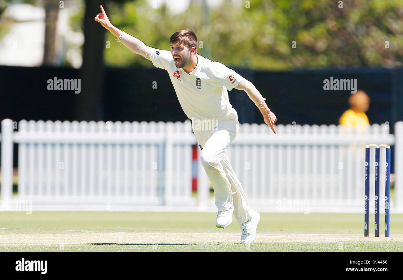 England's Mark Wood celebrates the wicket of Travis Dean during day two ...