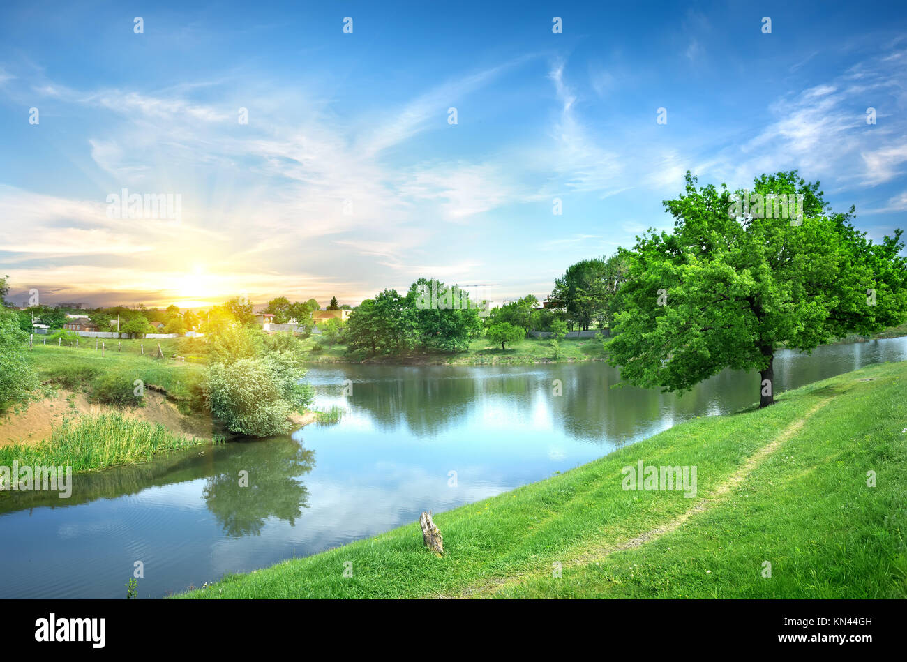 Spring landscape with the river and the sun Stock Photo - Alamy