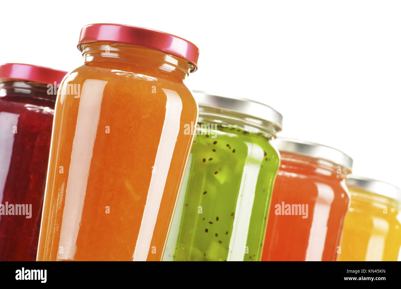 Jars of fruity jams isolated on white background. Preserved fruits ...