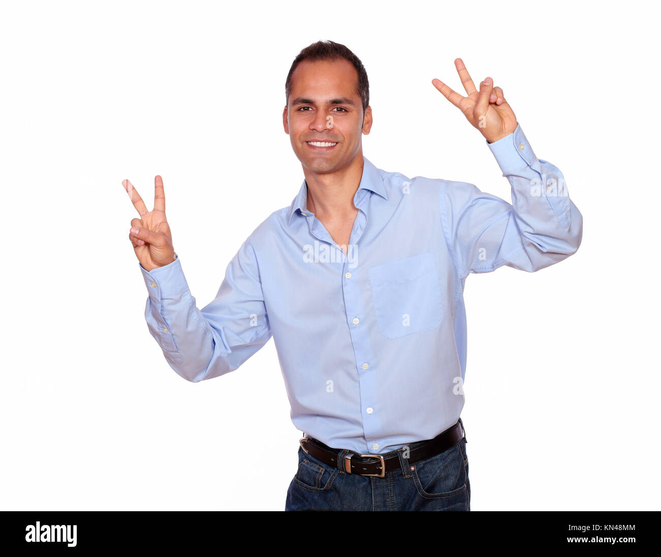 Portrait of a charming man smiling and showing you victory sign against ...