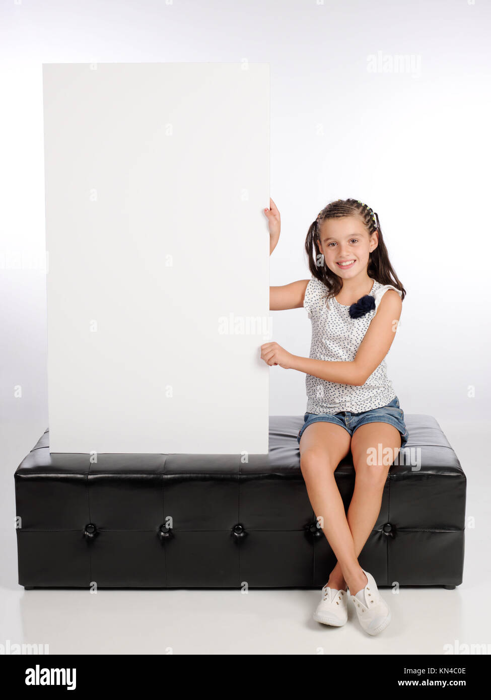 Young girl holding a sign Stock Photo - Alamy