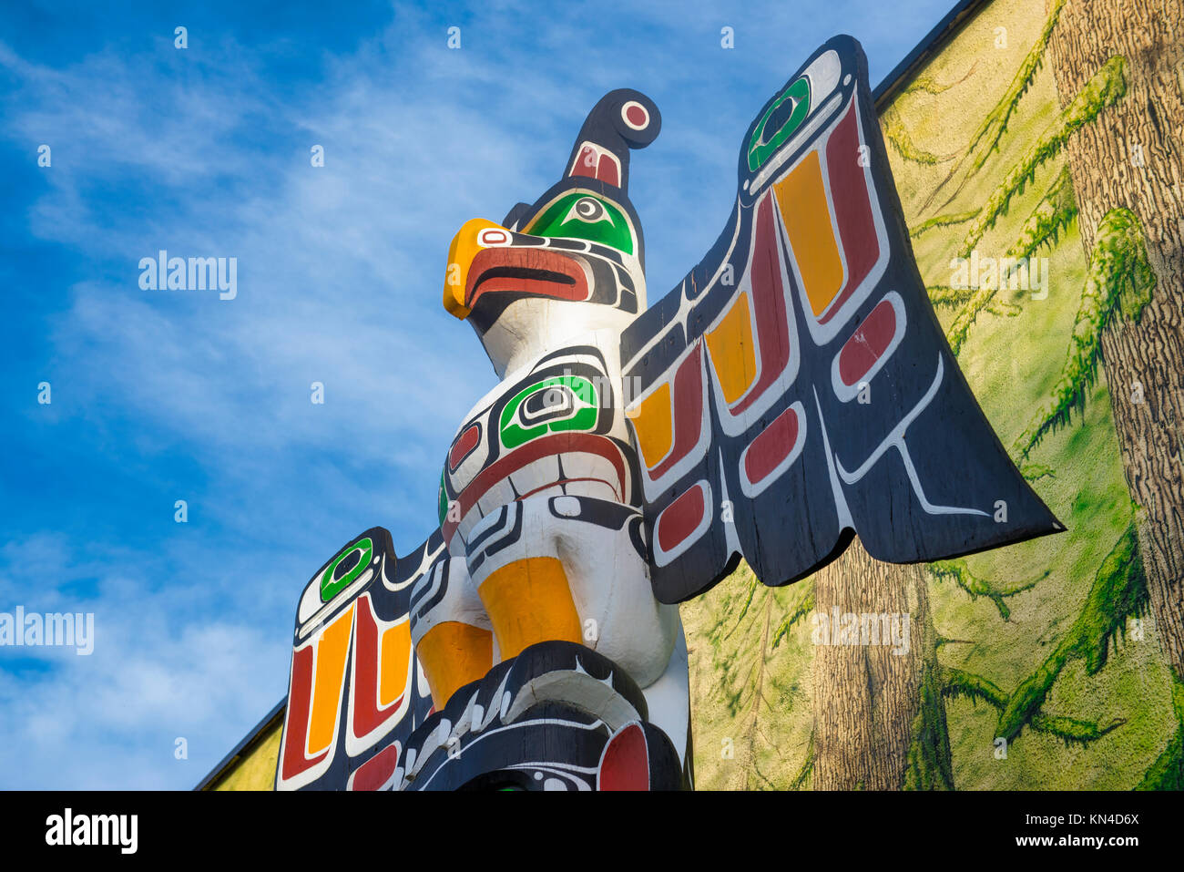 View of ancient colorful Totem Pole with blue sky behind it in Duncan ...