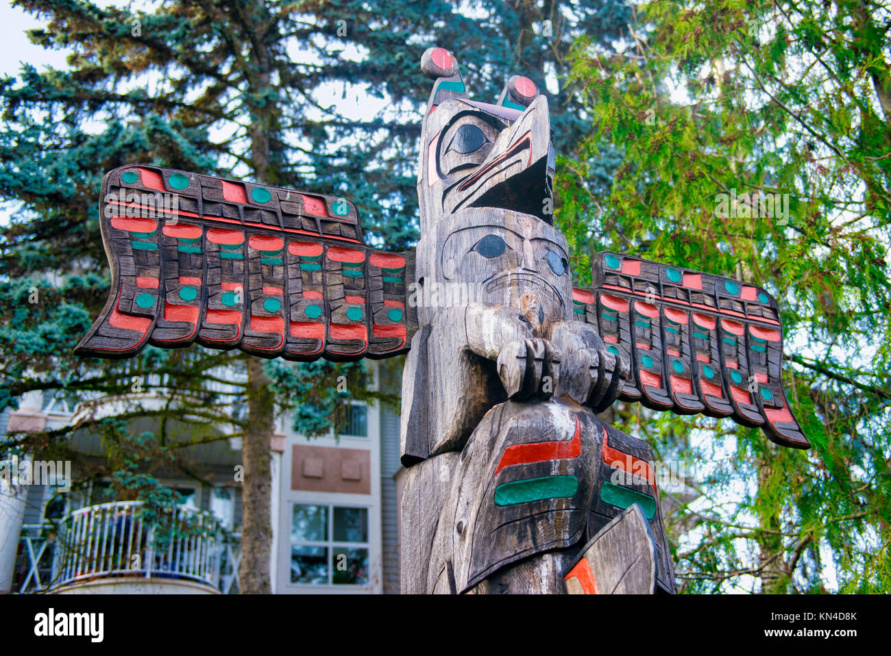 View of ancient colorful Totem Pole with blue sky behind it in Duncan ...