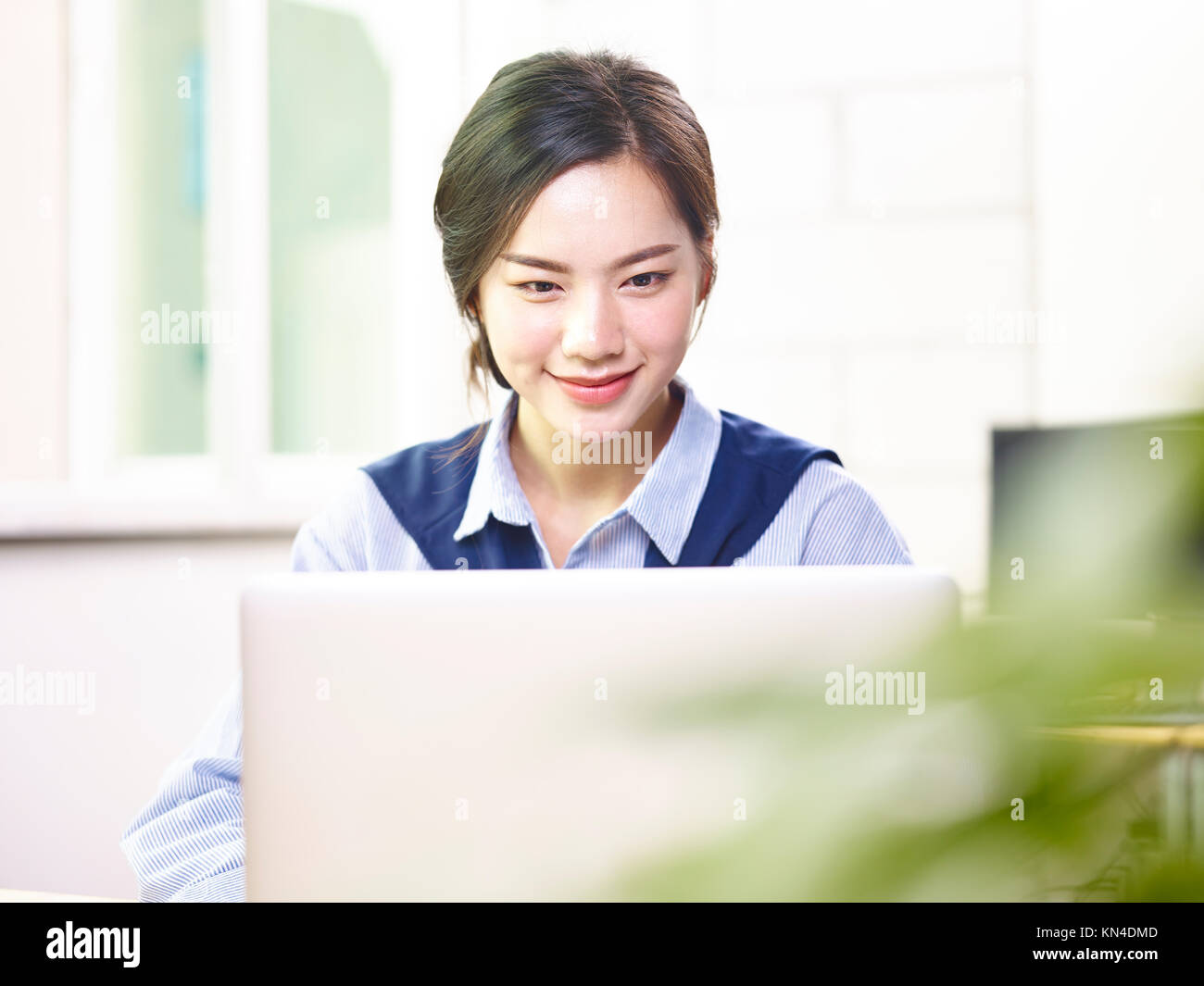young asian businesswoman sitting at desk working in office using ...