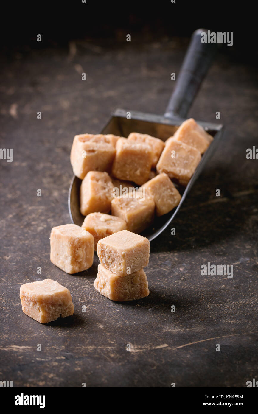 Vintage pastry scoop with fudge candy over dark background Stock Photo ...