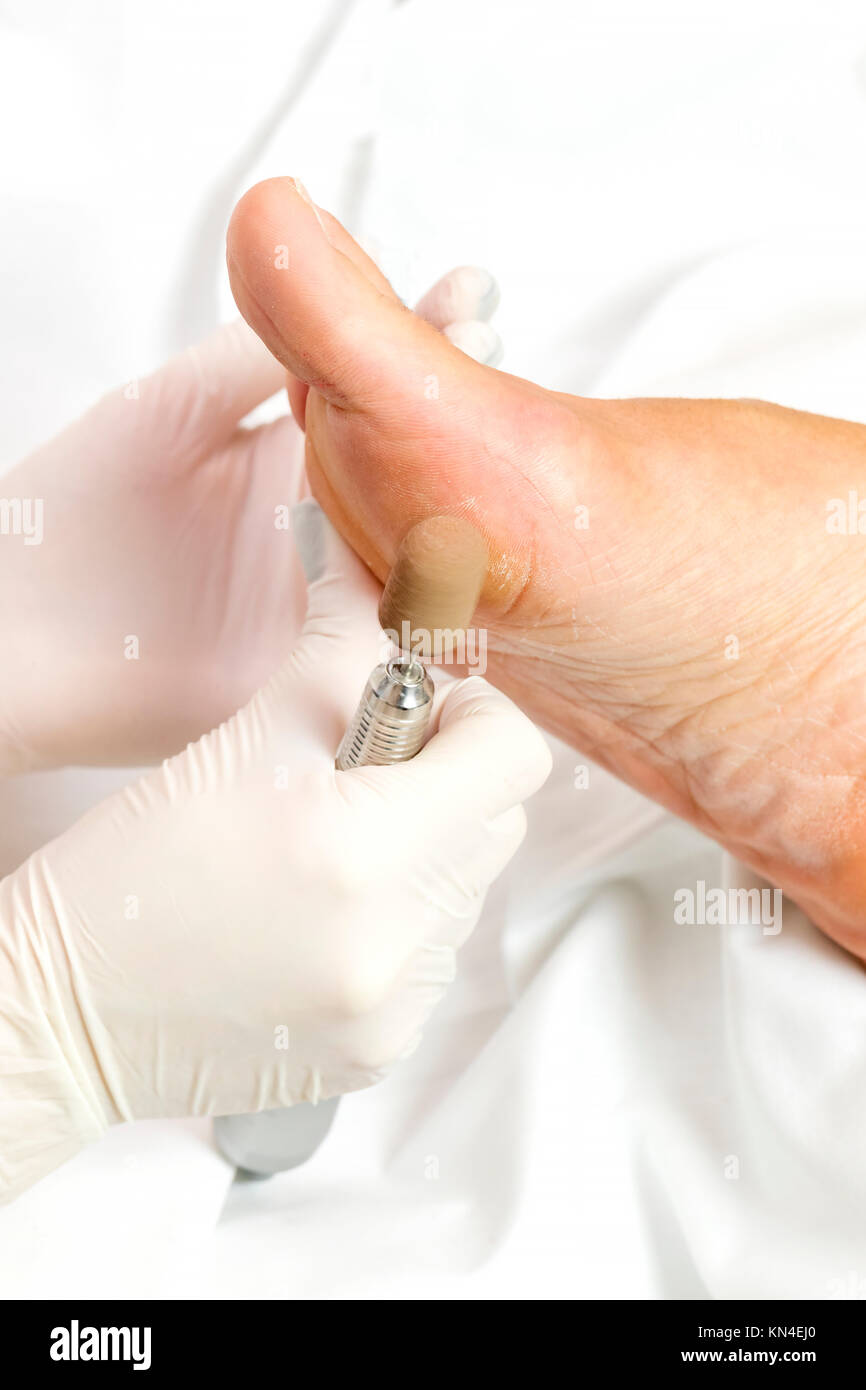 Female foot in the process of pedicure procedure in a beauty salon ...