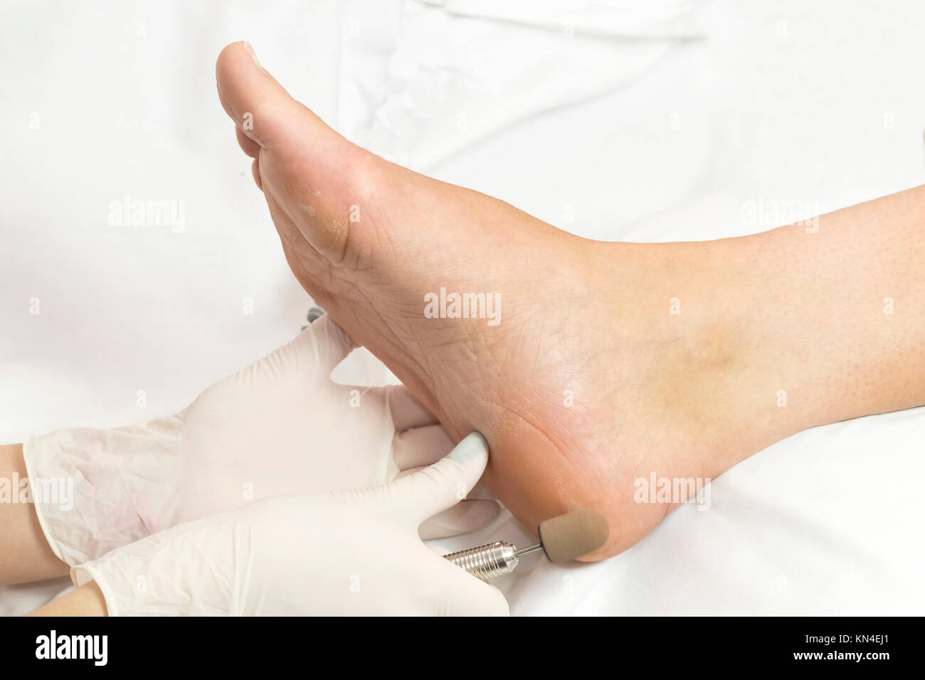 Female foot in the process of pedicure procedure in a beauty salon ...