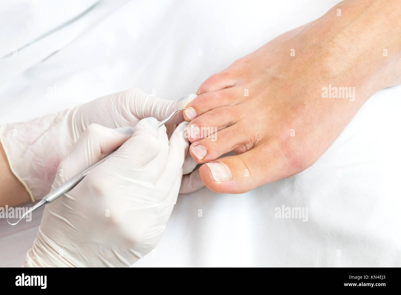 Female foot in the process of pedicure procedure in a beauty salon ...