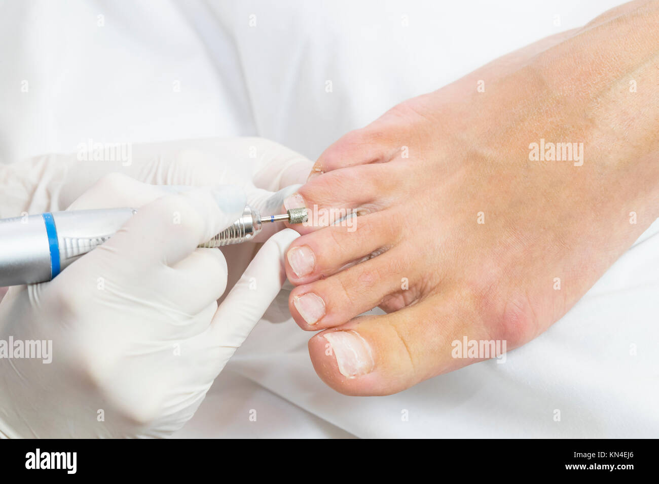 Female foot in the process of pedicure procedure in a beauty salon ...