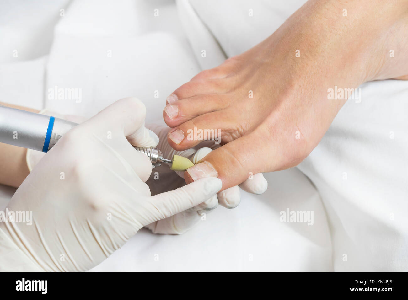 Female foot in the process of pedicure procedure in a beauty salon ...