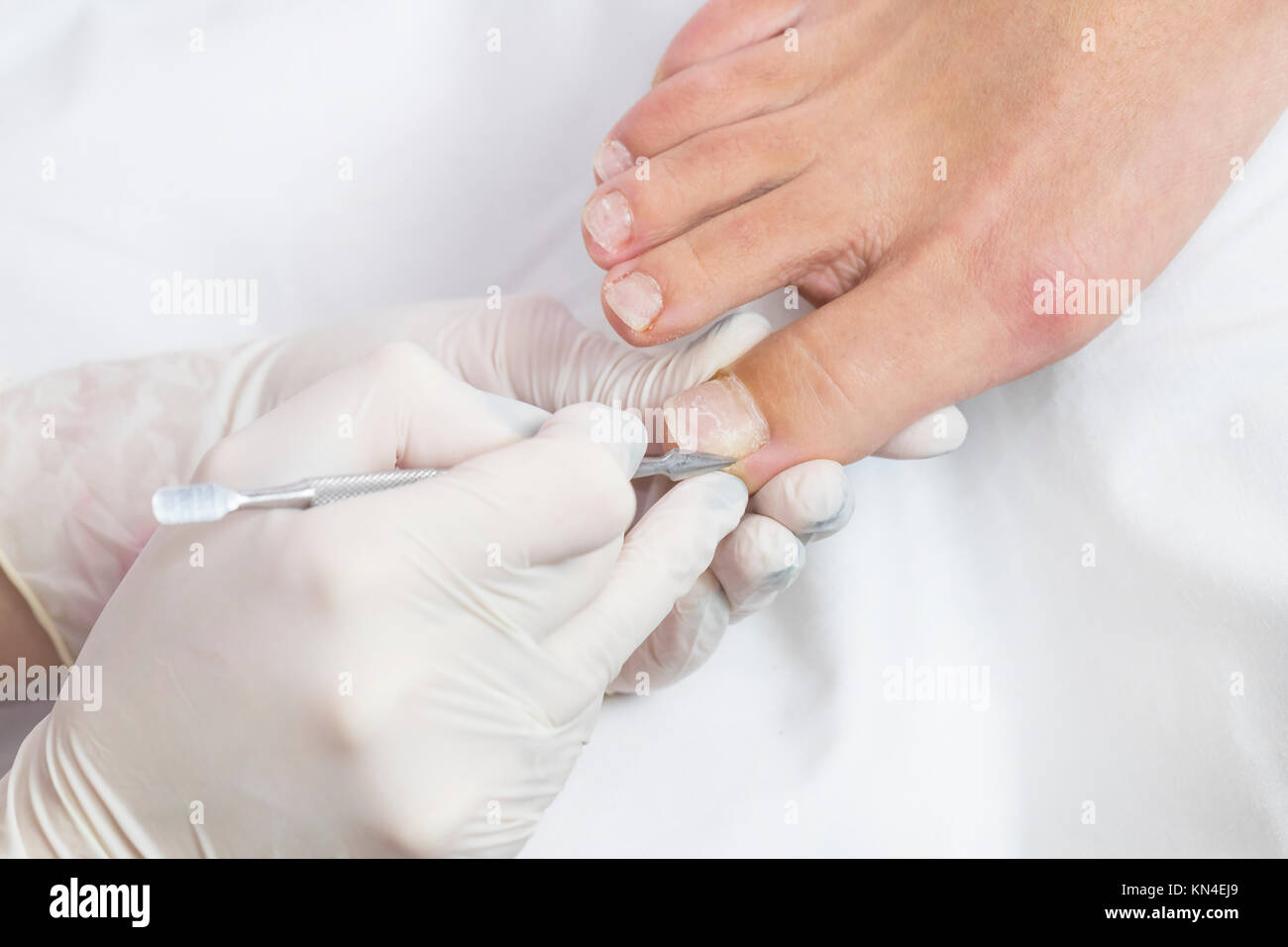 Female foot in the process of pedicure procedure in a beauty salon ...
