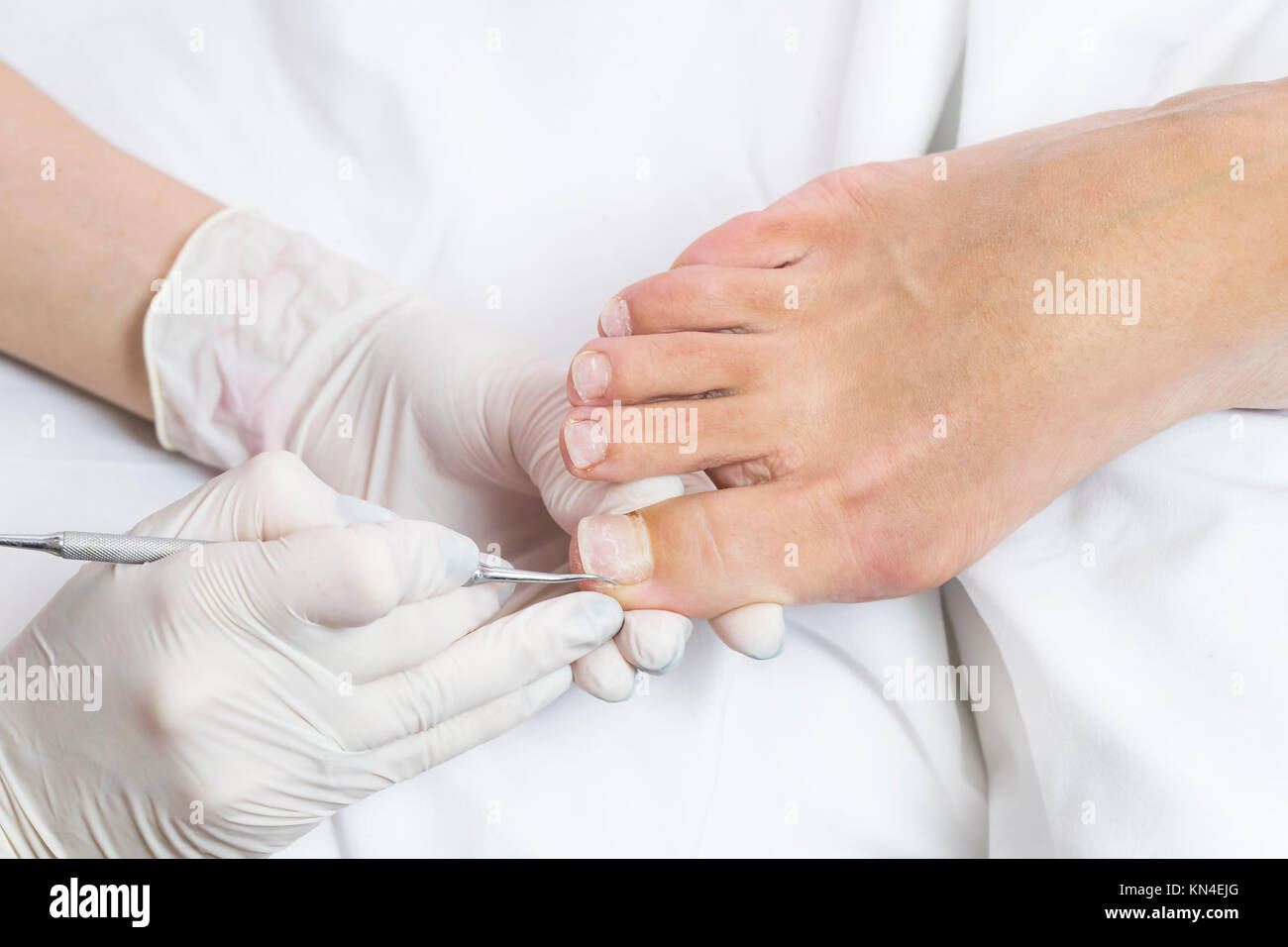 Female foot in the process of pedicure procedure in a beauty salon ...