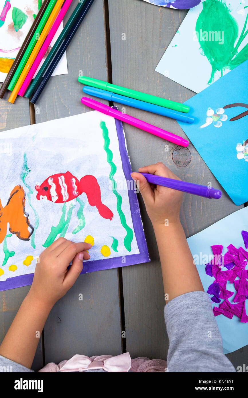 Child drawing. Top view of child hands with pencil painting picture on ...