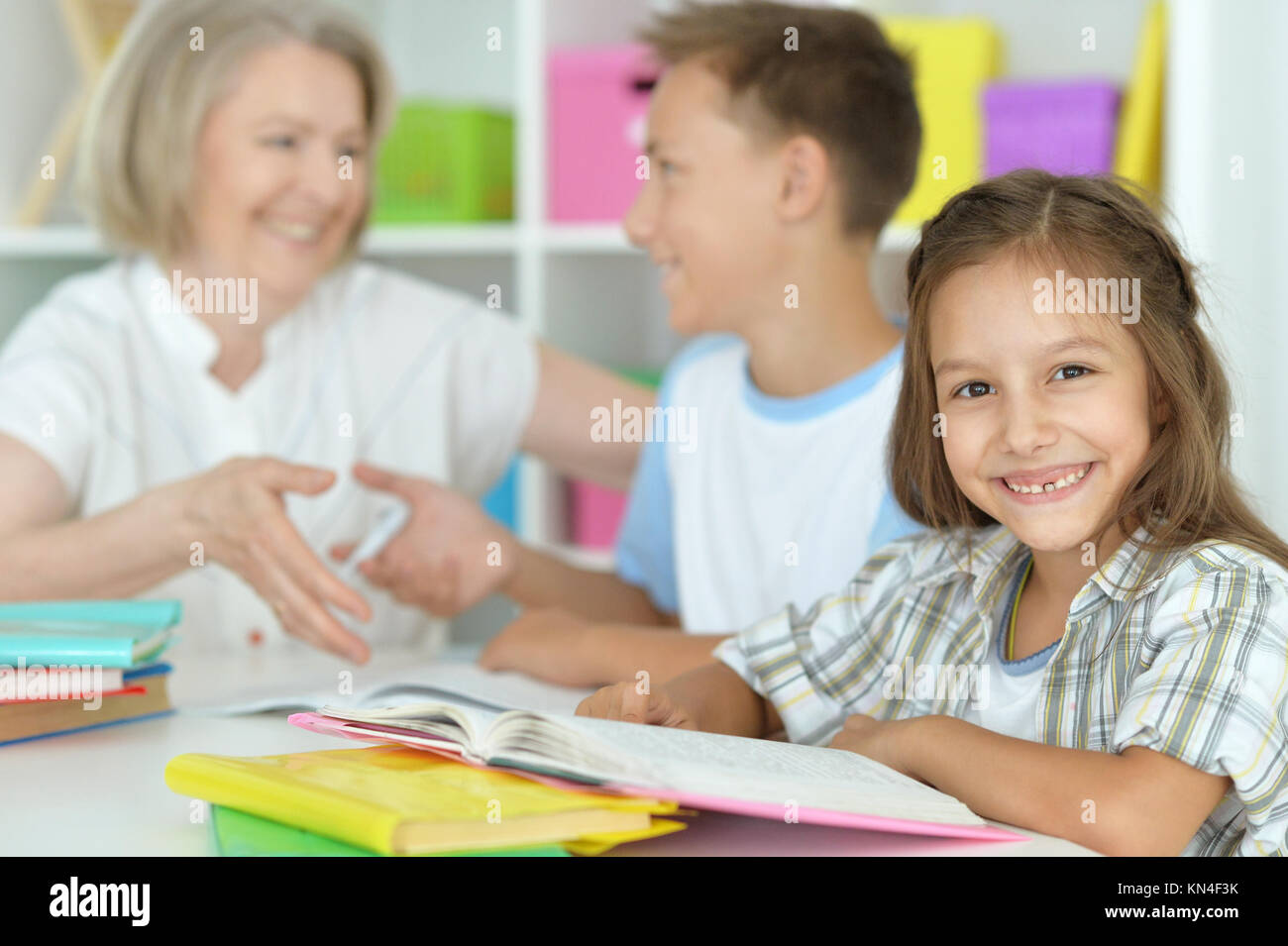 granny with grandchildren doing homework Stock Photo - Alamy