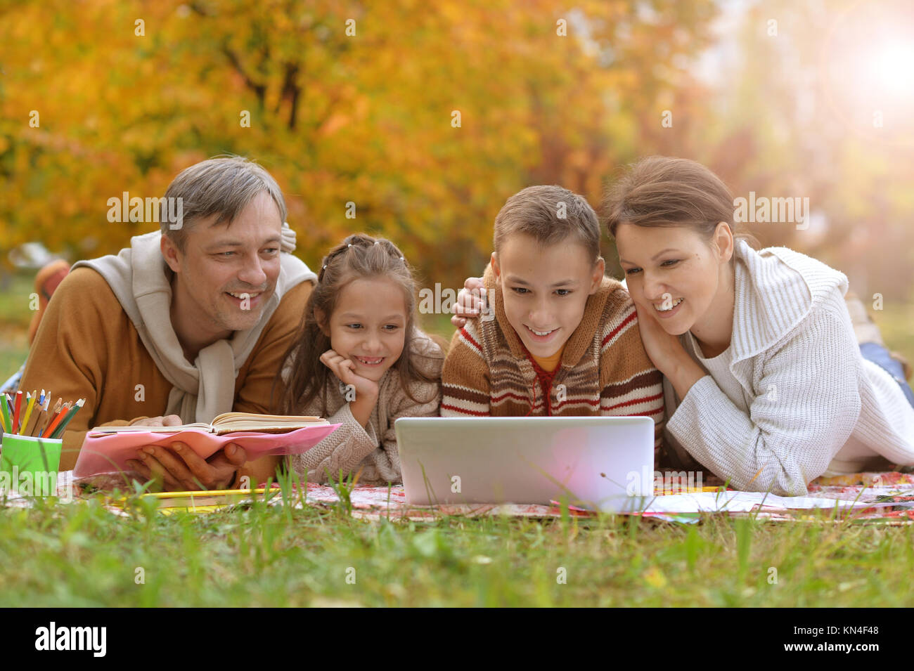 parents and children doing homework Stock Photo - Alamy