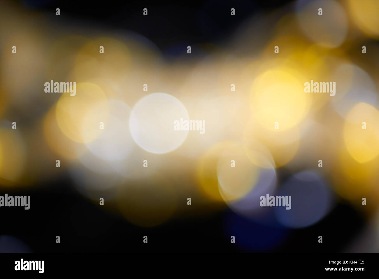 Beautiful blurry yellow lights on a dark background Stock Photo - Alamy