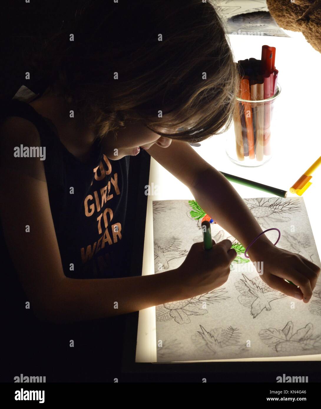 Young girls and mother enjoy a day of art work, drawing and imagination ...