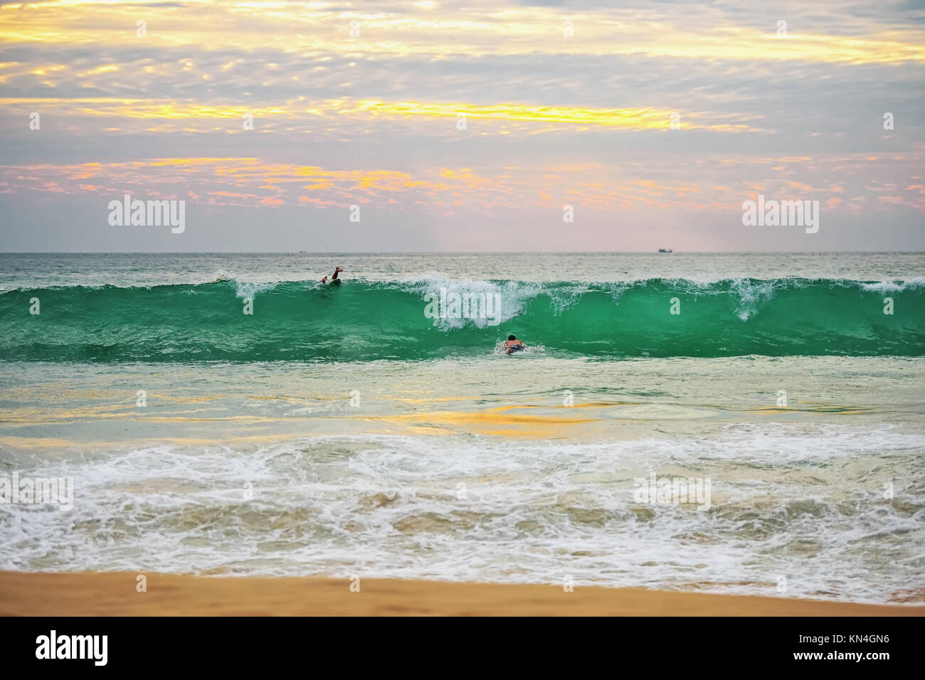 Beautiful high tide surf at sunset in the sun. The horizontal frame ...