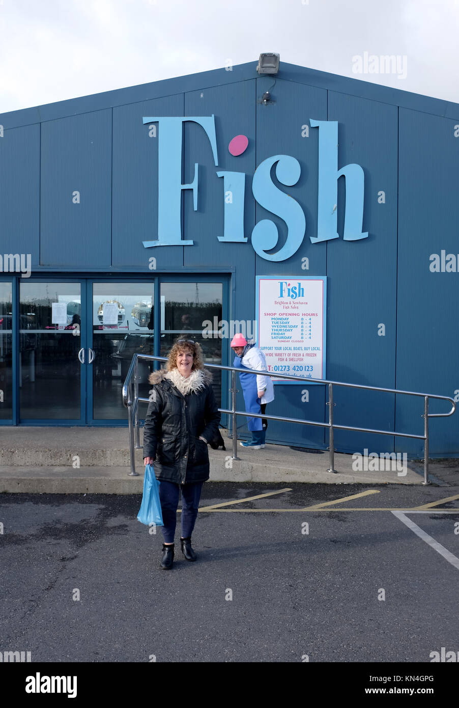 Female shopper leaving Fish the well known fresh fishmongers shop at ...
