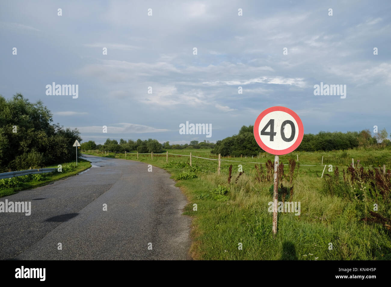 Empty road with speed limit sign Stock Photo - Alamy
