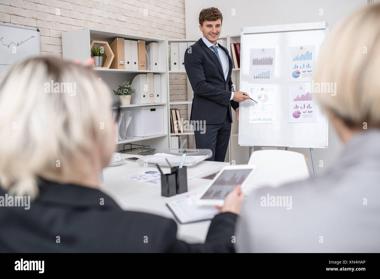 Young Man Presenting Project in Office Stock Photo - Alamy