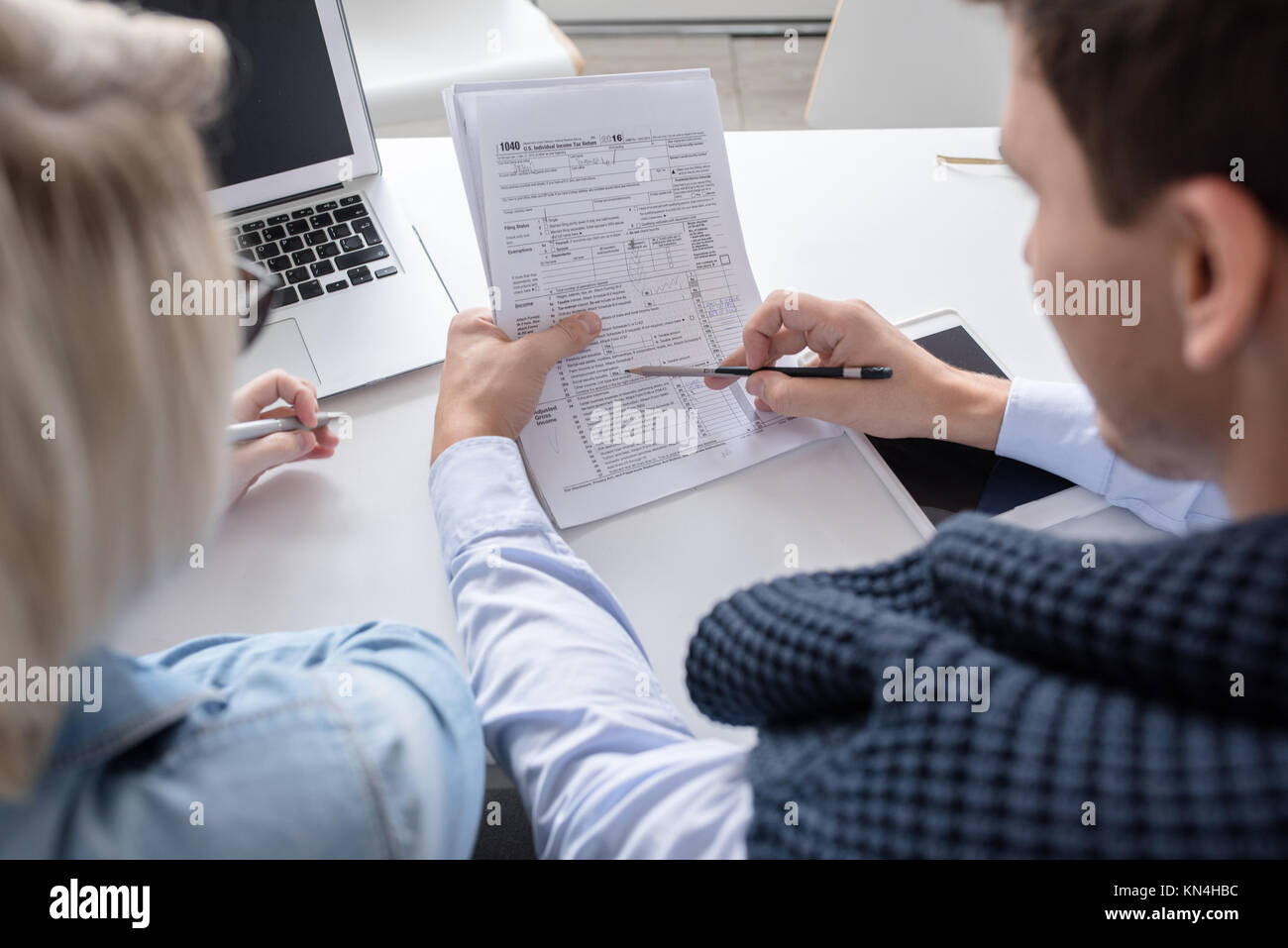 Business People Discussing Report in Meeting Stock Photo - Alamy