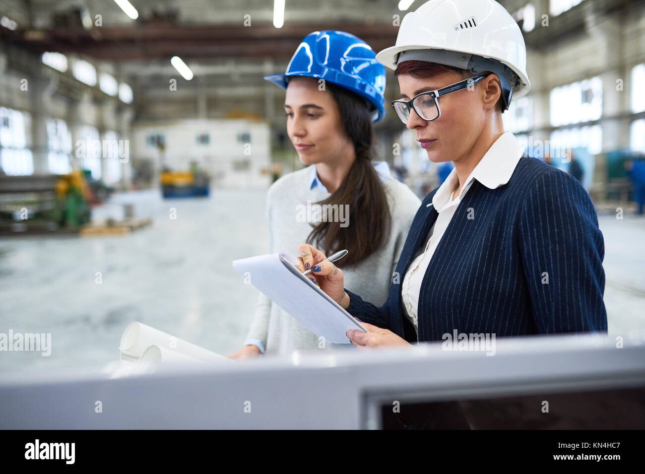 Female Inspectors Wrapped up in Work Stock Photo - Alamy