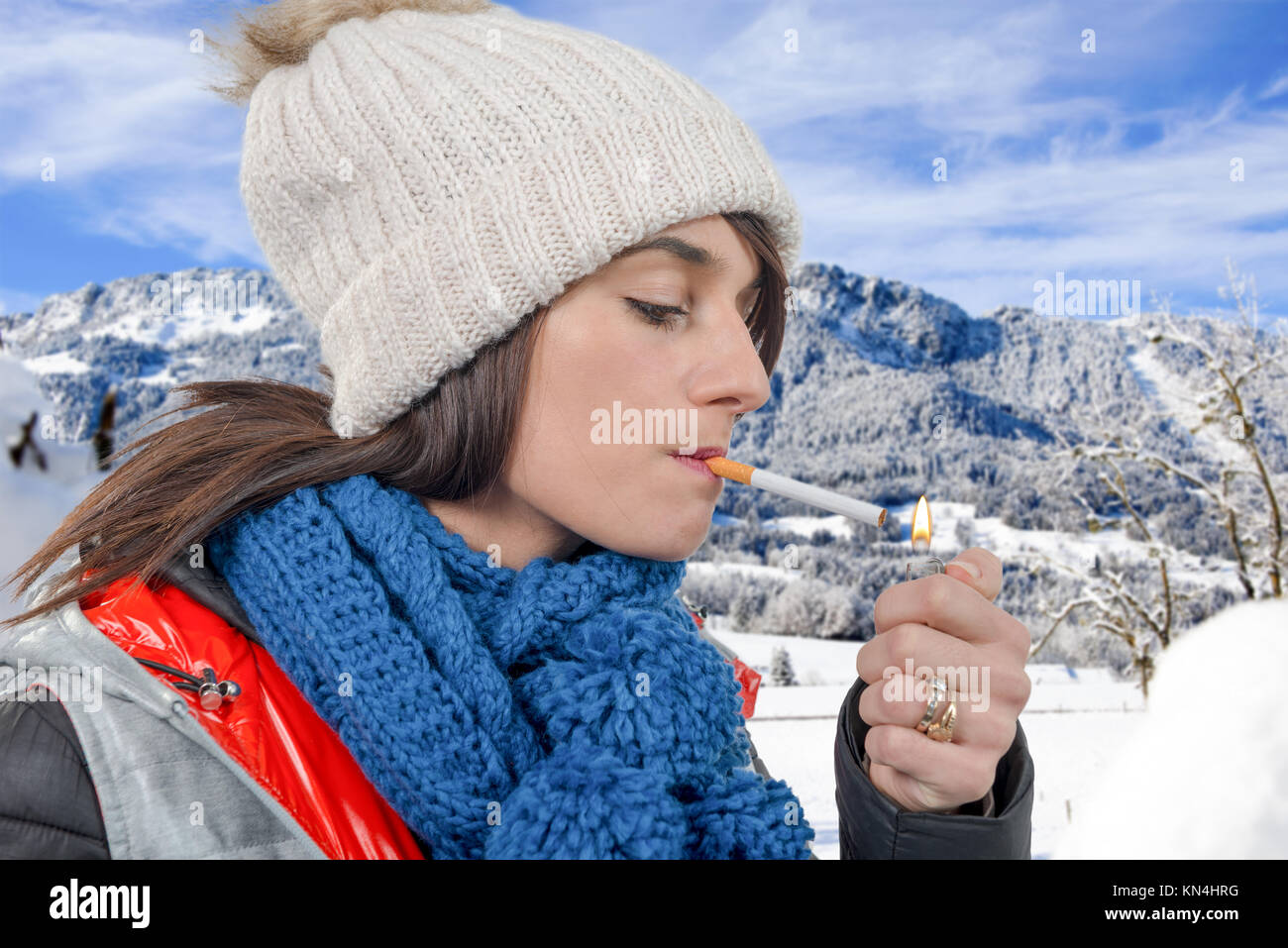 a pretty young woman with winter hat smoking a cigarette Stock Photo ...