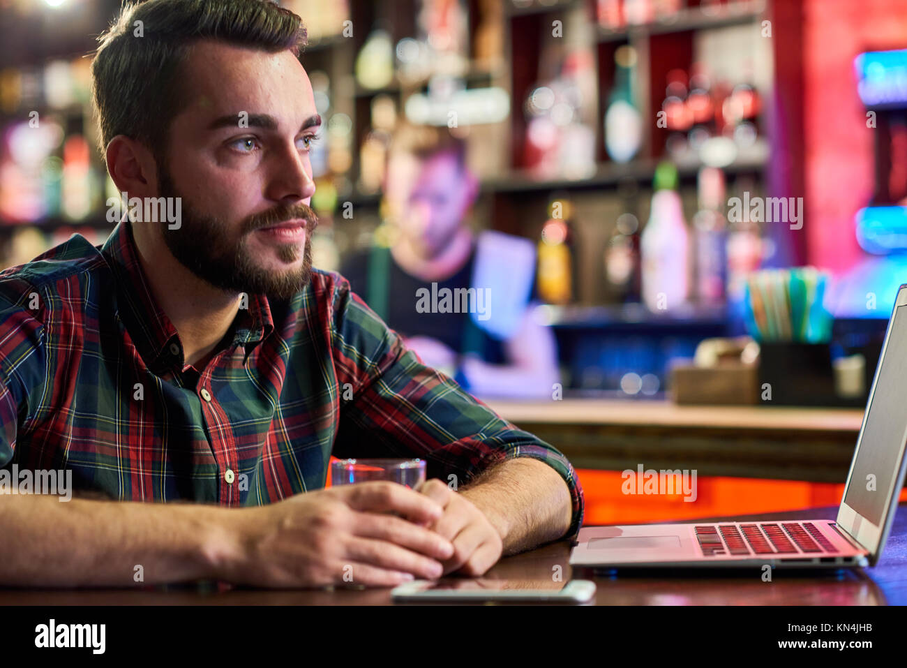 Young Man with Laptop in Bar Stock Photo - Alamy
