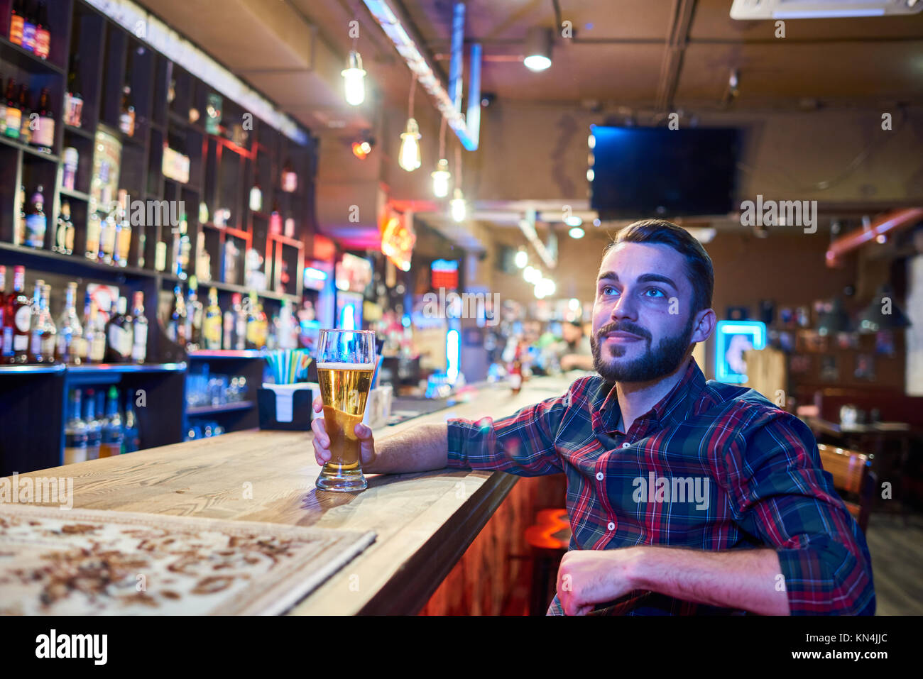 Man Watching TV in Beer Pub Stock Photo - Alamy