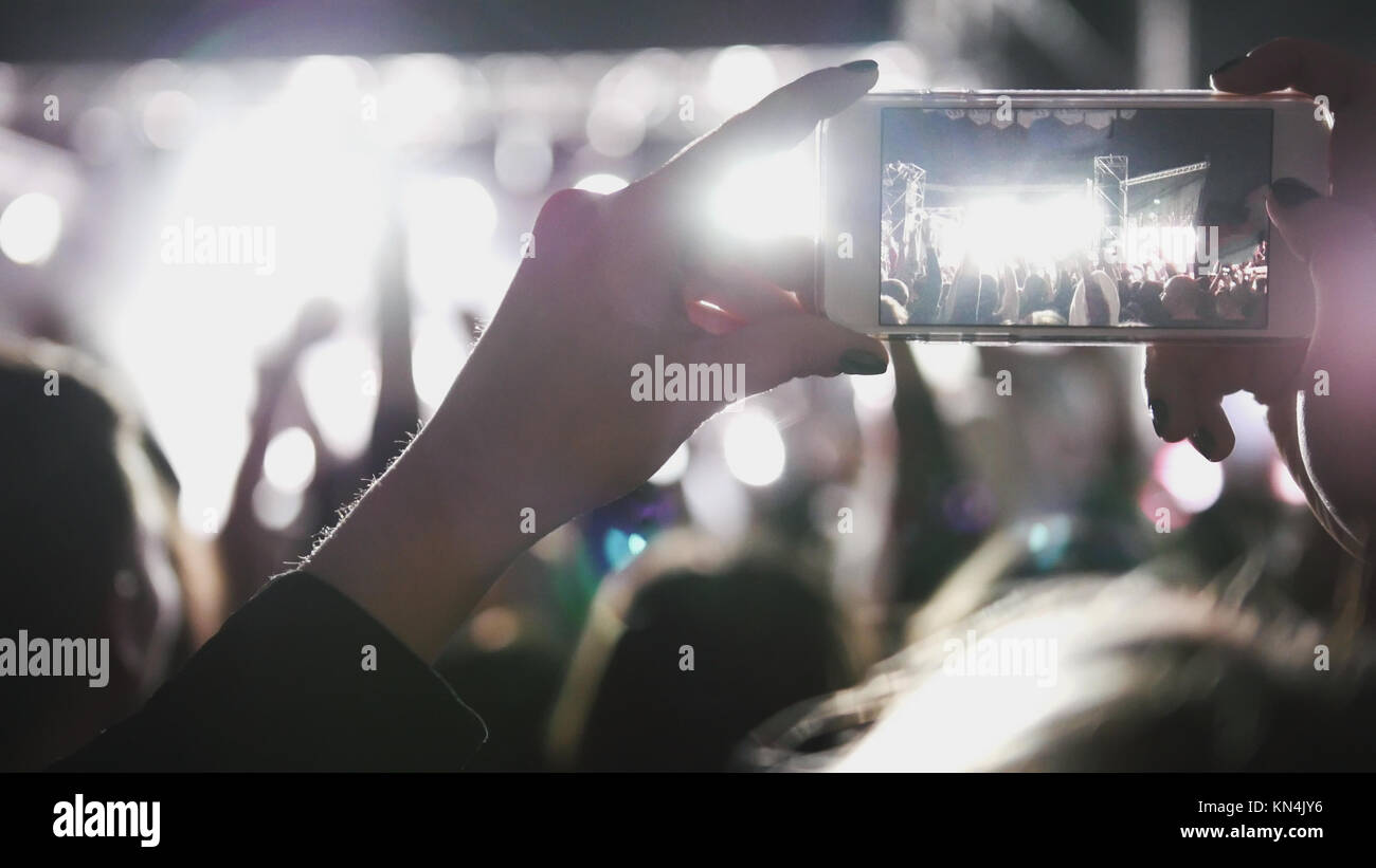 Spectators at the music concert shooting video on the smartphone Stock ...