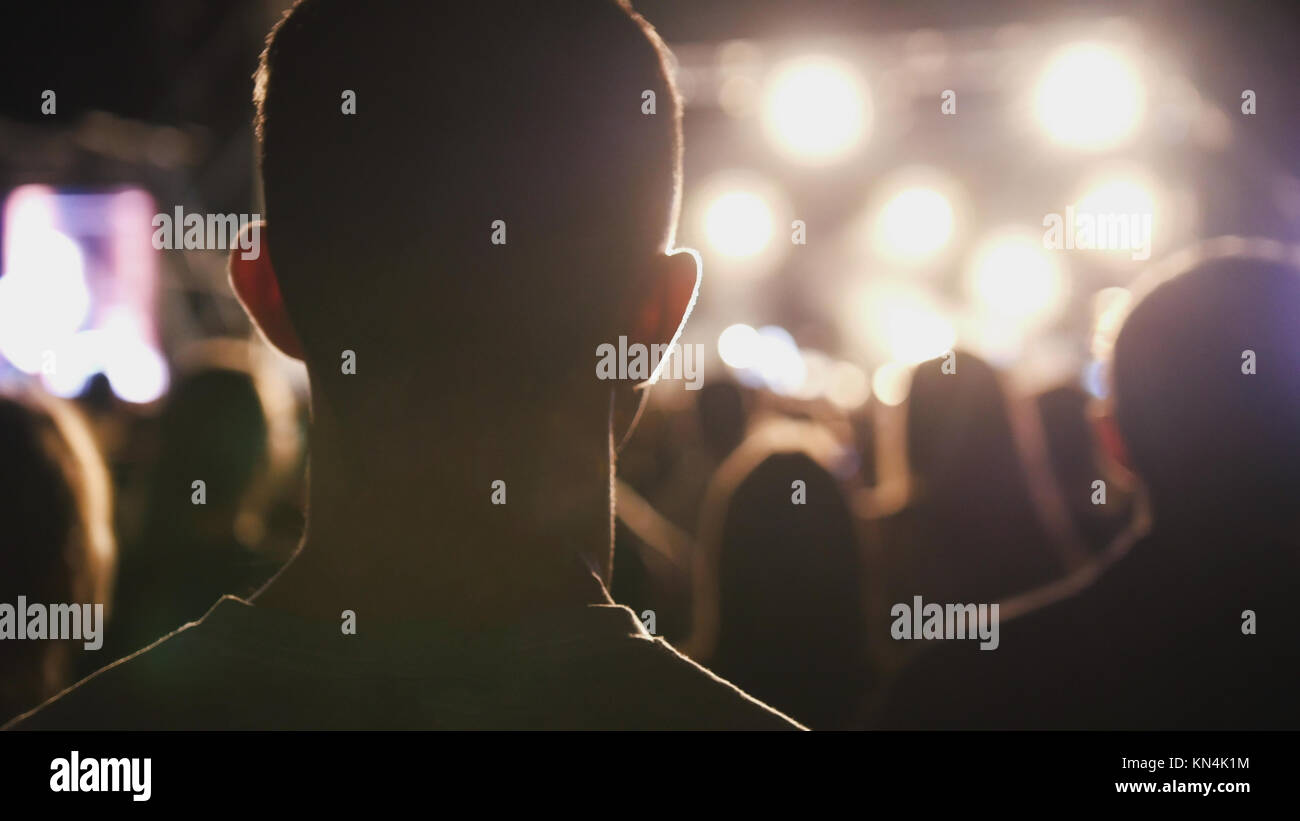 Man listens the rock concert in stadium Stock Photo - Alamy