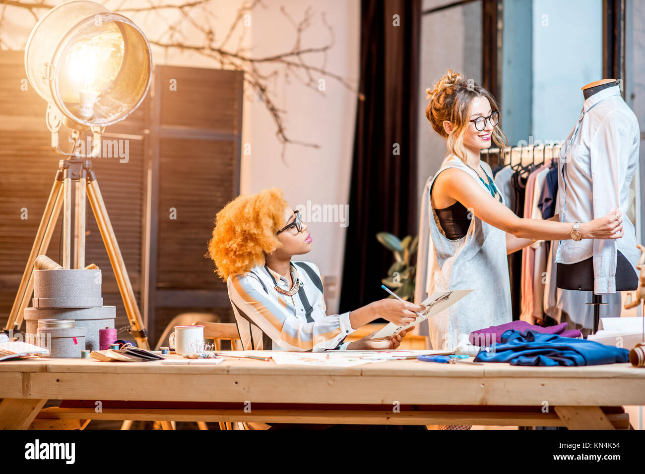 Fashion designers working at the office Stock Photo - Alamy