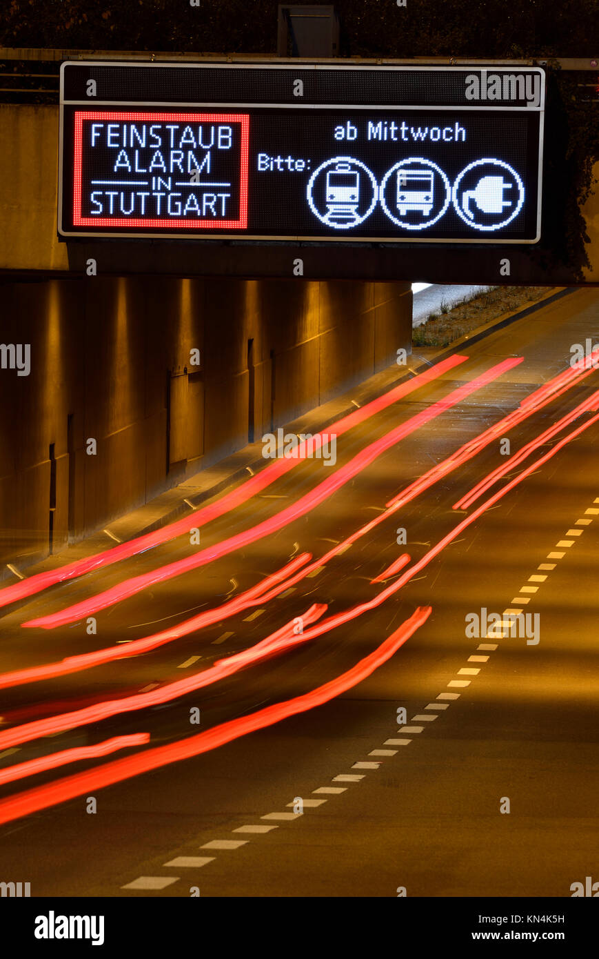 Information sign fine particles alarm on highway, light traces ...