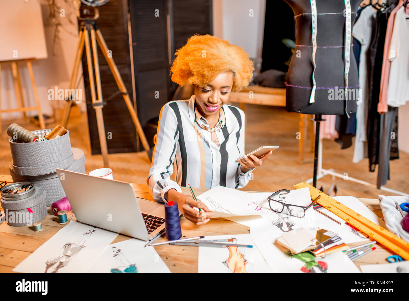 Fashion designer working at the office Stock Photo - Alamy