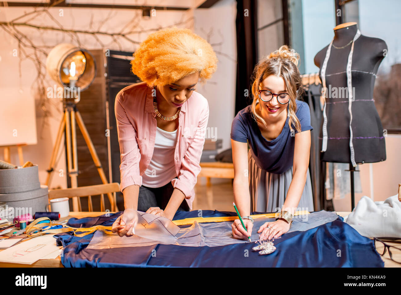 Young female tailors working with clothes Stock Photo - Alamy