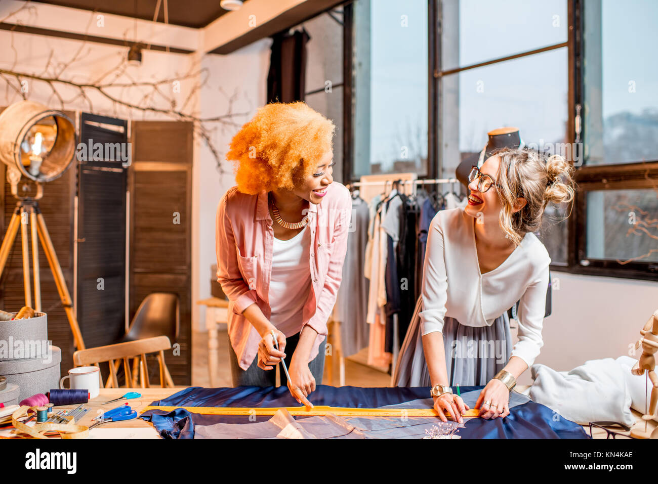 Young female tailors working with clothes Stock Photo - Alamy